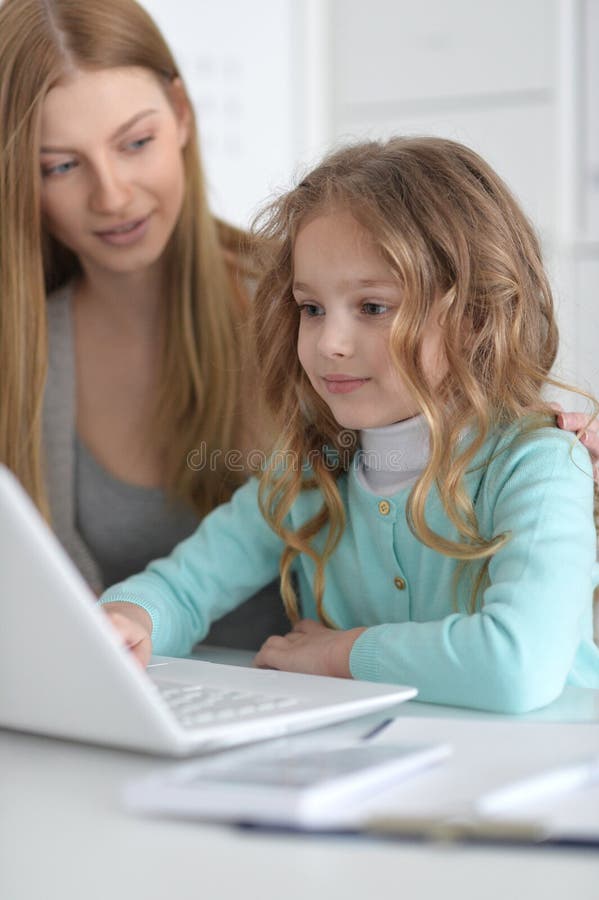Mother and Daughter Looking at Laptop Computer Stock Image - Image of ...