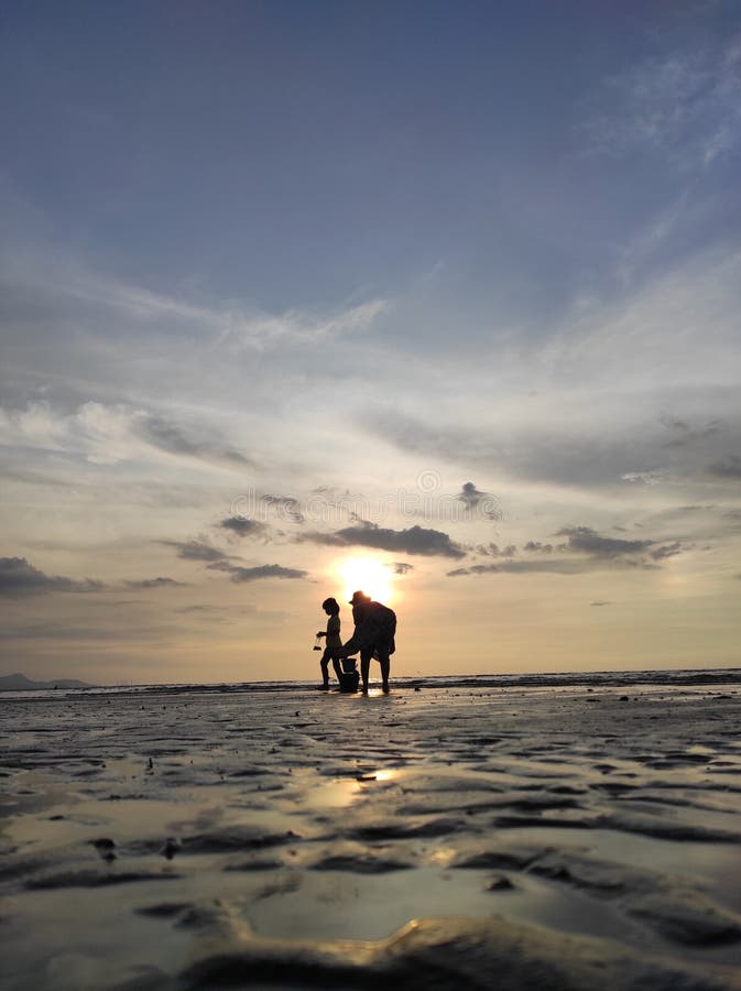 Mother and Daughter Looking for Shells on the Beach Editorial Image ...