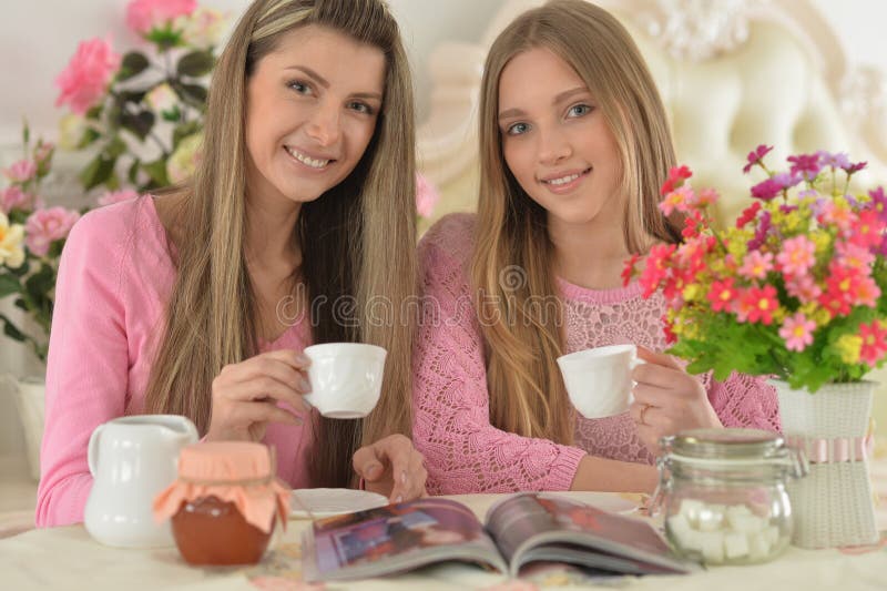 Mother with Daughter with Magazine Stock Photo - Image of closeup, face ...