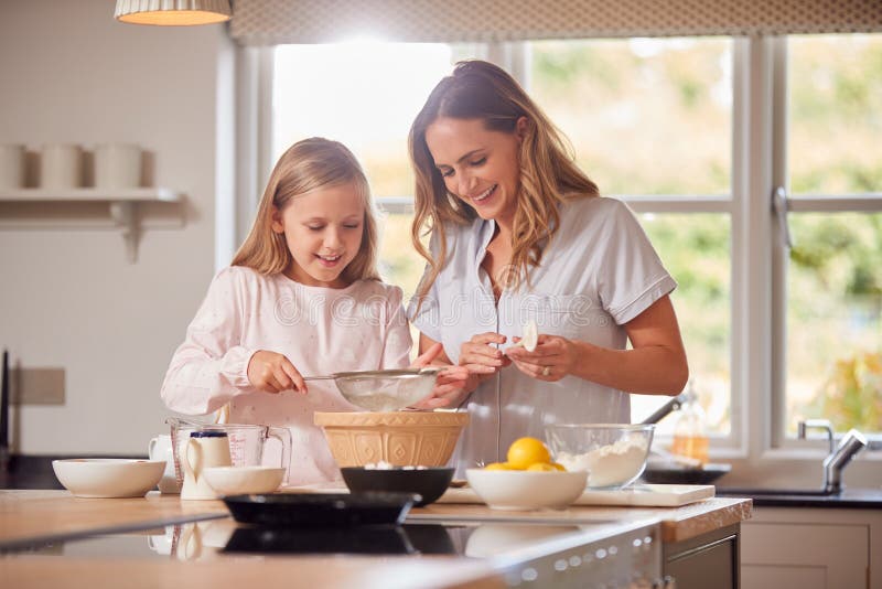 Mother and Daughter Making Pancakes in Kitchen at Home Together Stock ...