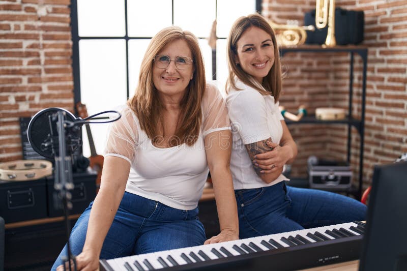 Mother and Daughter Musicians Smiling Confident at Music Studio Stock ...