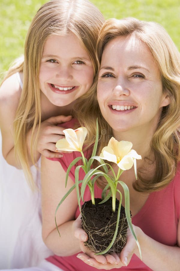 Mother and Daughter Outdoors Holding Flower Stock Image - Image of ...