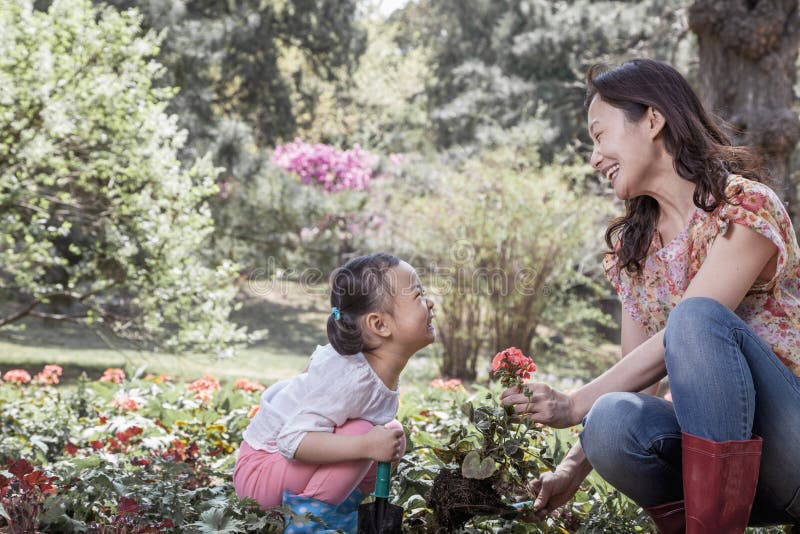 Mother and Daughter Planting Flowers. Stock Image - Image of horizontal ...