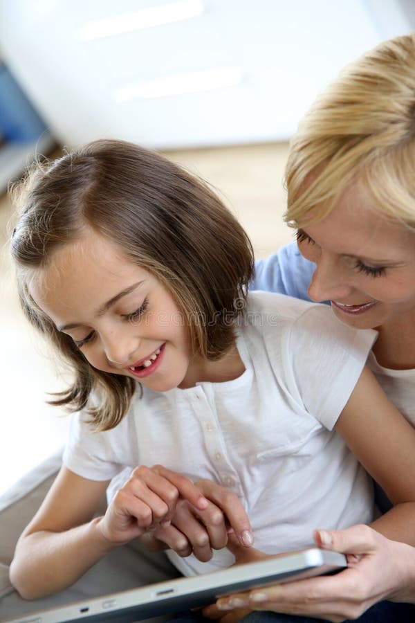 Mom with Little Girl Using Tablet Stock Photo - Image of complicity ...