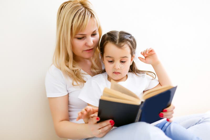 Mother and Daughter Reading Story at Home Together Stock Photo - Image ...
