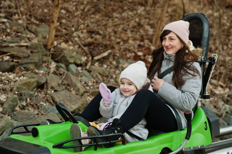 Mother with Daughter Ride Electric Sleigh on Rails Stock Photo - Image ...