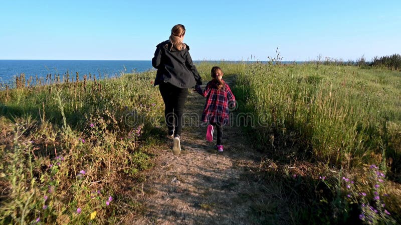 Mother and Daughter Running on a Spring Path Stock Video - Video of ...