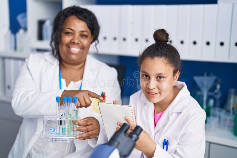 Mother and Daughter Scientists Holding Test Tubes Writing on Notebook ...