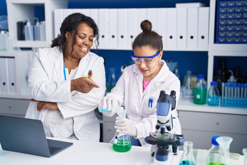 Mother and Daughter Scientists Measuring Liquid at Laboratory Stock ...