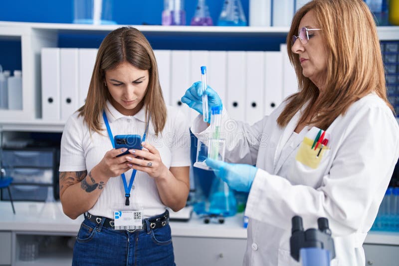 Mother and Daughter Scientists Using Smartphone Holding Test Tubes at ...
