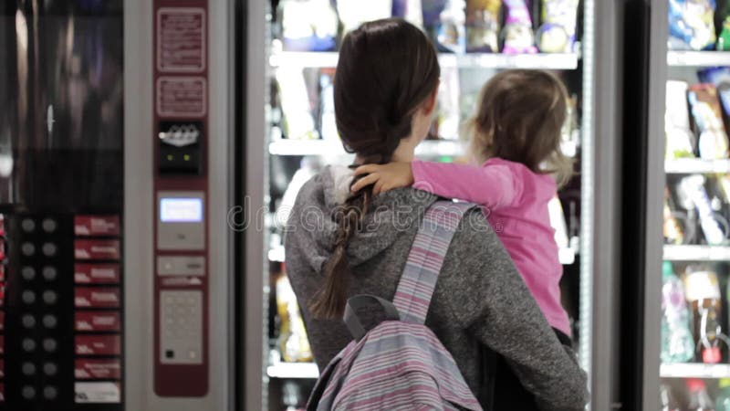 Mother and Daughter Selecting a Snacks at Vending Machine Inside ...