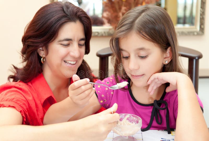 Mother and Daughter Sharing a Dessert Stock Photo - Image of mother ...