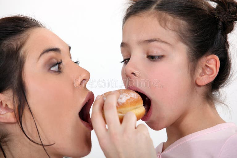 Mother and Daughter Sharing Doughnut Stock Photo - Image of biscuit ...