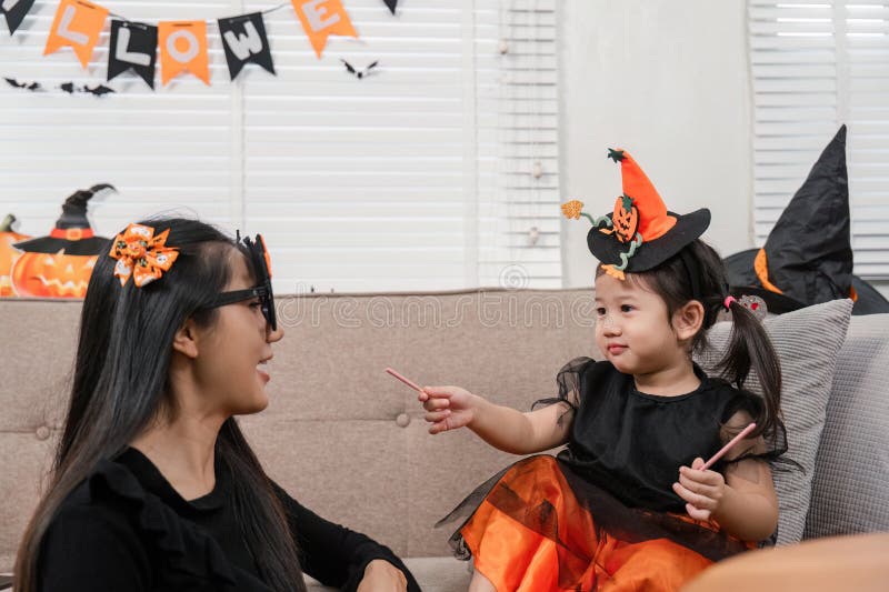 Mother and Daughter Sharing a Playful Halloween Interaction Stock Photo ... Mother and Daughter Sharing a Playful Halloween Interaction Stock Photo ...