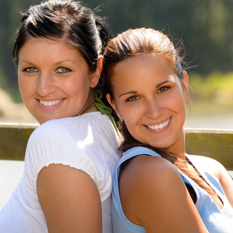 Mother and Daughter Sitting Back To Back Stock Photo - Image of ...