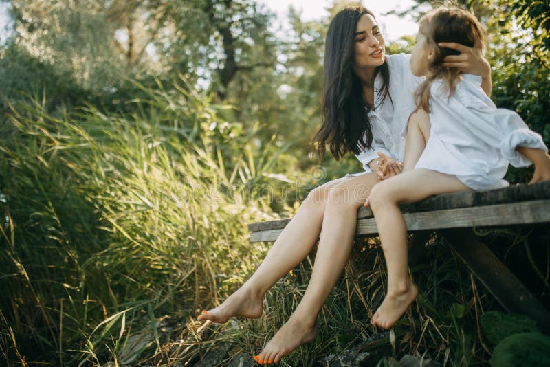 Mother and Daughter Sitting on Bench in the Forest Stock Image - Image ...