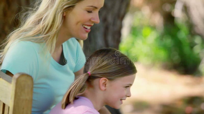 Mother and Daughter Sitting on a Bench in a Park Stock Image - Image of ...