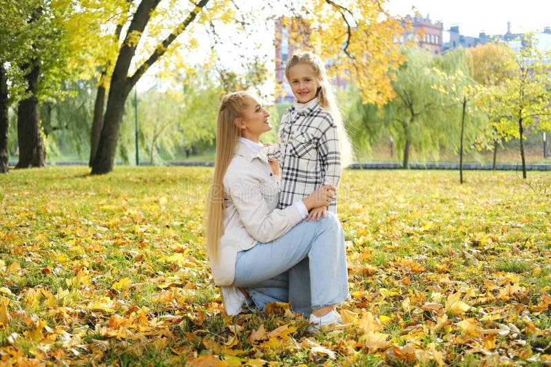 Mother And Daughter Spend Time Together In Autumn Park Stock Image