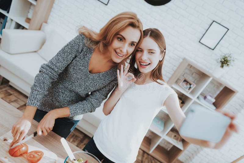 Mother and Daughter Taking Selfie in Kitchen. Stock Image - Image of ... Mother and Daughter Taking Selfie in Kitchen. Stock Image - Image of ...