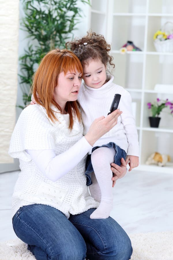 Mother and Daughter Using Cell Phone Stock Photo - Image of daughter ...