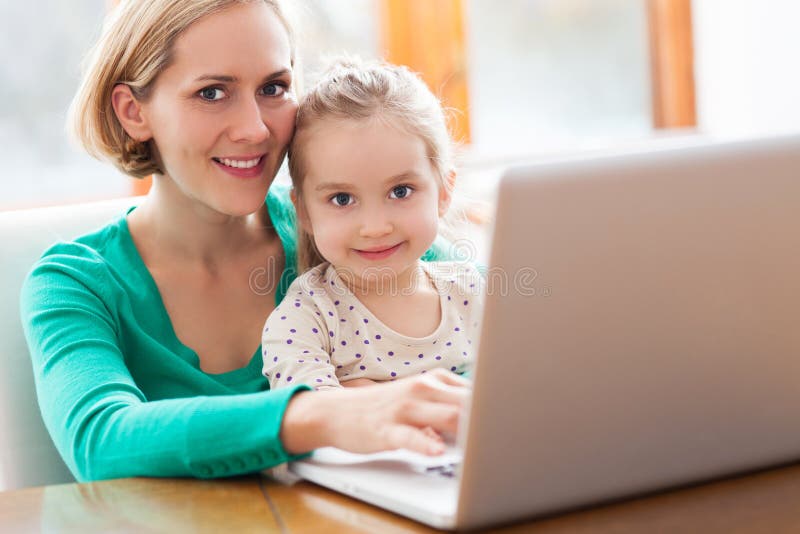 Woman and Little Girl Playing on a Laptop Stock Photo - Image of ...