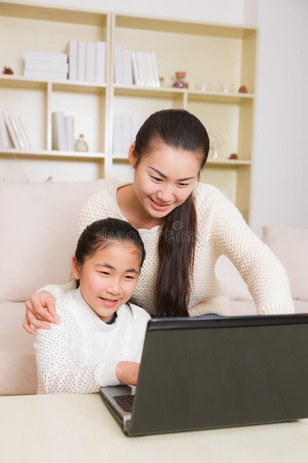 Mother and Daughter Using Laptop Stock Photo - Image of portrait ...