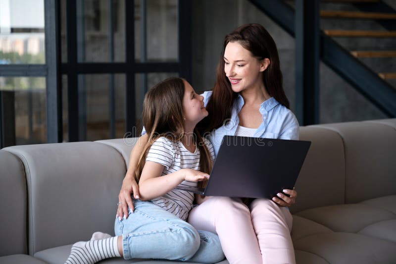 Mother and Daughter Using Modern Netbook for Online Study, Watching ...