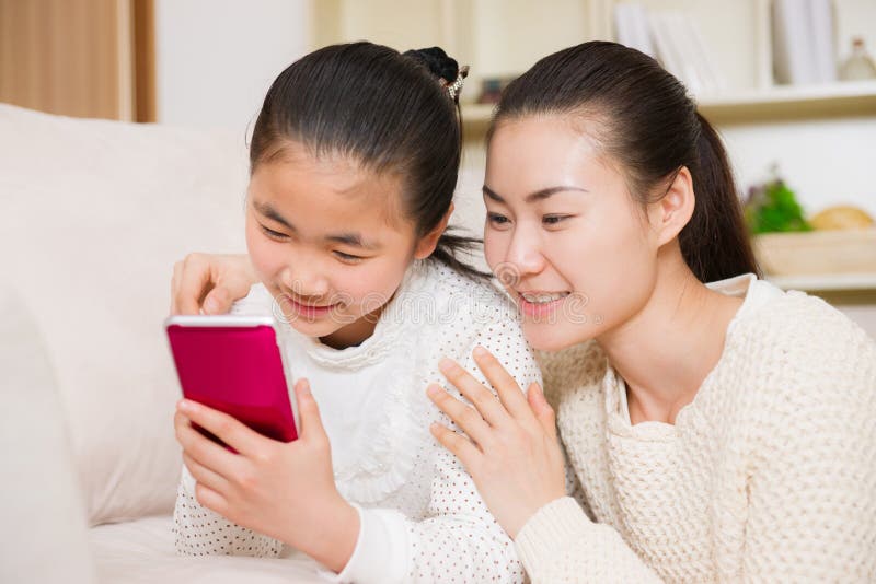 Mother and Daughter Using Smart Phone Stock Photo - Image of cellphone ...