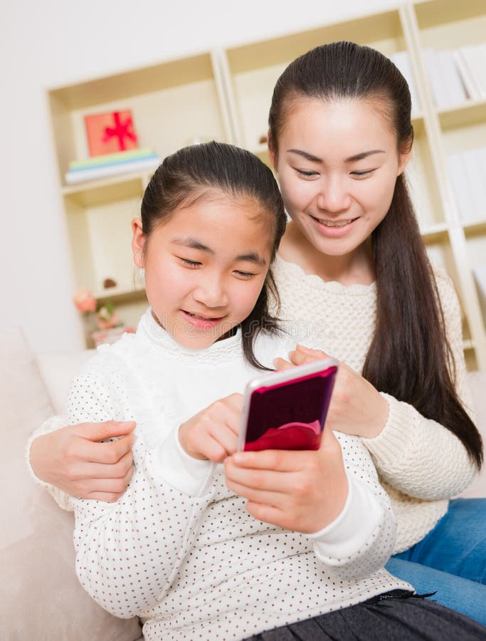 Mother and Daughter Using Smart Phone Stock Image - Image of leisure ...