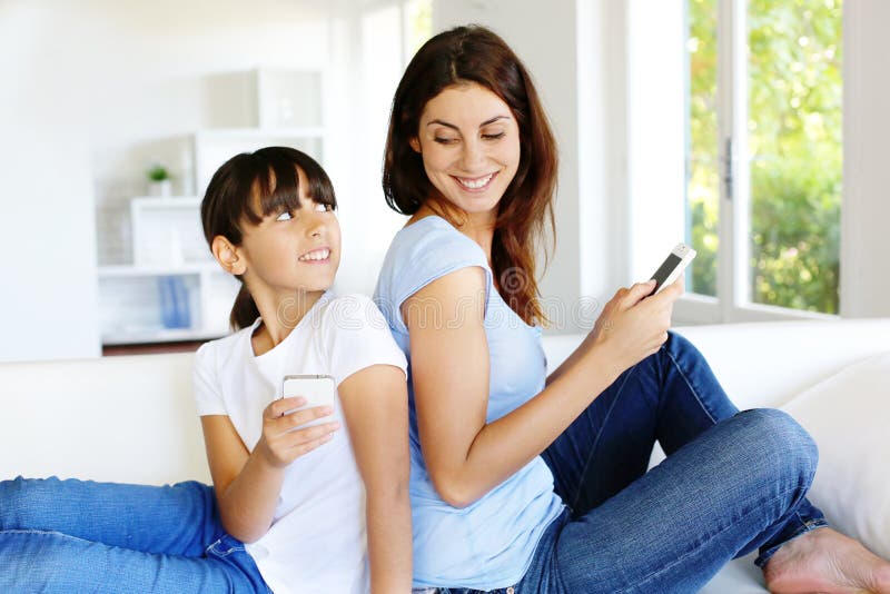 Mother and Daughter Using Smartphones Stock Photo - Image of happy ...
