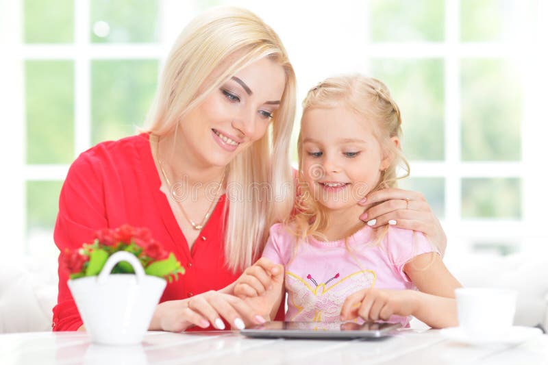 Mother and Daughter Using Tablet Computer Stock Photo - Image of mother ... Mother and Daughter Using Tablet Computer Stock Photo - Image of mother ...