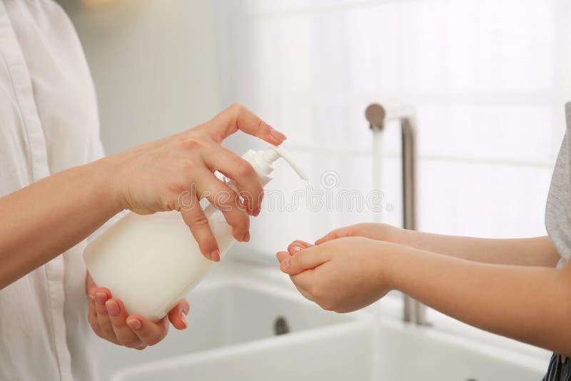 Mother and Daughter Washing Hands with Liquid Soap Together at Home ... Mother and Daughter Washing Hands with Liquid Soap Together at Home ...