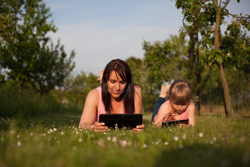 Mother and Daughter Working on a Tablet. Stock Image - Image of ...