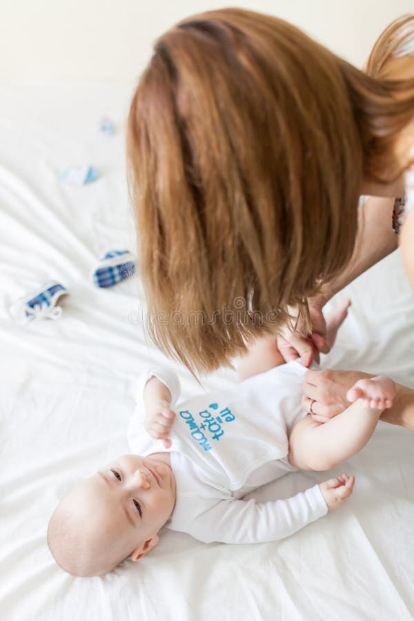 Mother Dressing Up Her Child Stock Photo - Image of parenthood ...