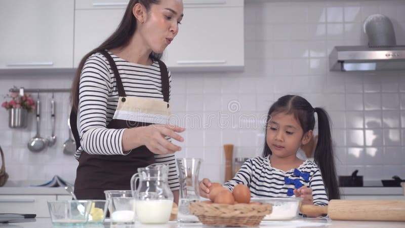 Mother and an Excited Child is Learning and Working Together Baking and ...