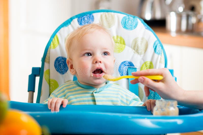 Mother feeding baby boy stock photo. Image of breakfast - 38036830
