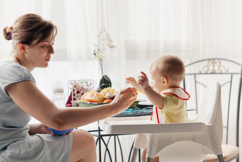 Mother Feeding Baby Boy stock photo. Image of motherhood - 53782844
