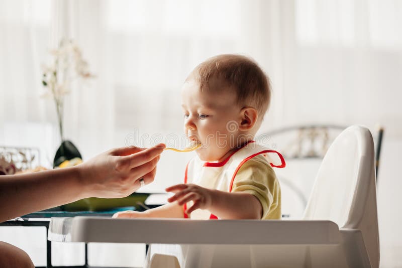 Mother Feeding Baby Boy stock photo. Image of months - 53820670