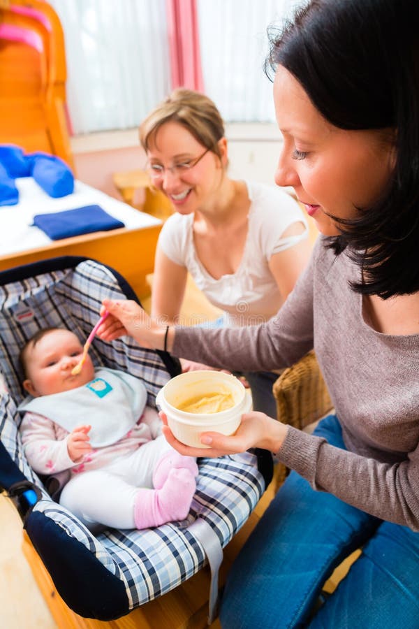 Mother is feeding the baby stock photo. Image of welfare - 18235556