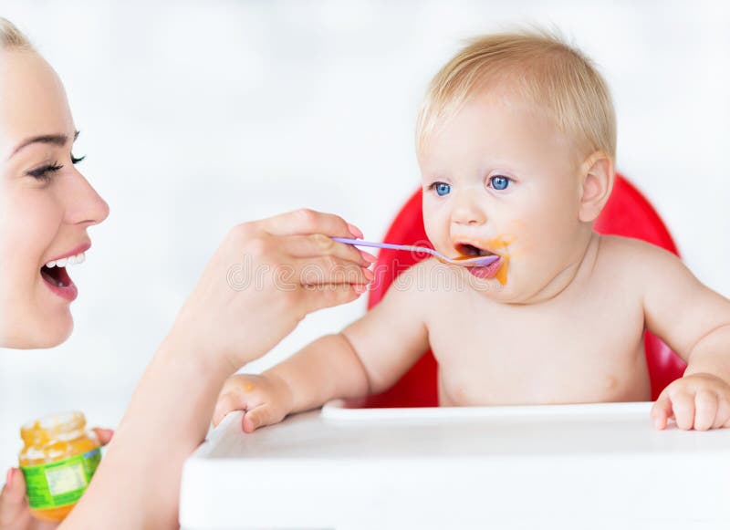 Mother feeding baby stock photo. Image of infant, family - 58563150