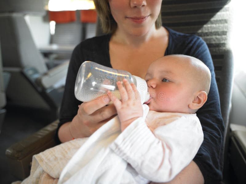 Mother Feeding Baby on Train Stock Image - Image of bonding, baby: 12021639