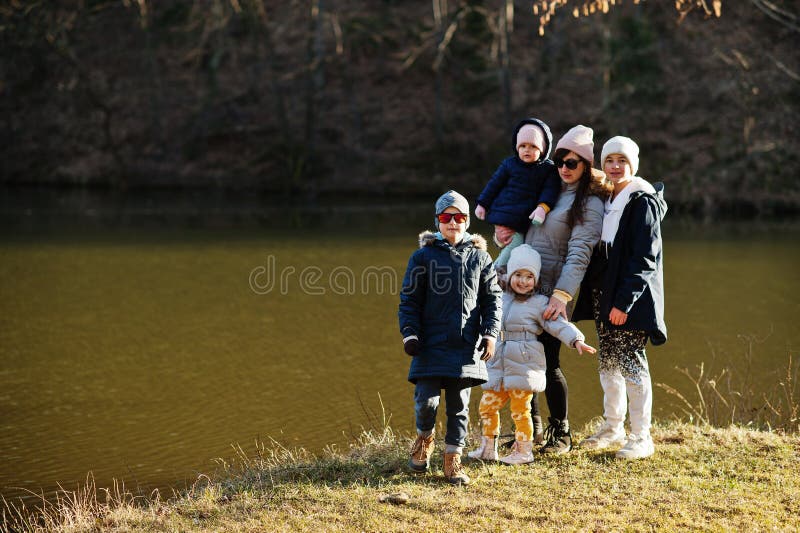 Mother with Four Kids in Pound at Early Spring Park Stock Photo - Image ...