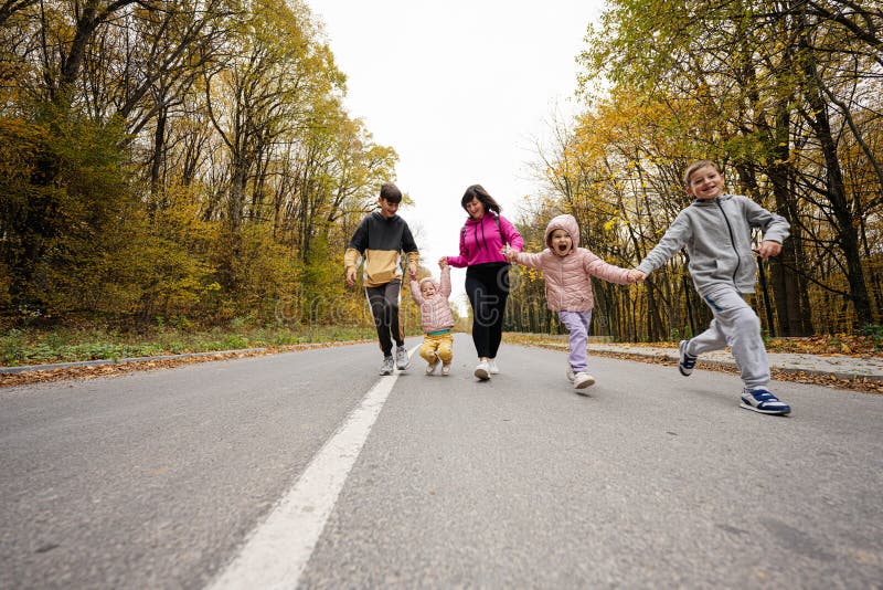 Mother with Four Kids Running on Road at Autumn Fall Forest Stock Image ...