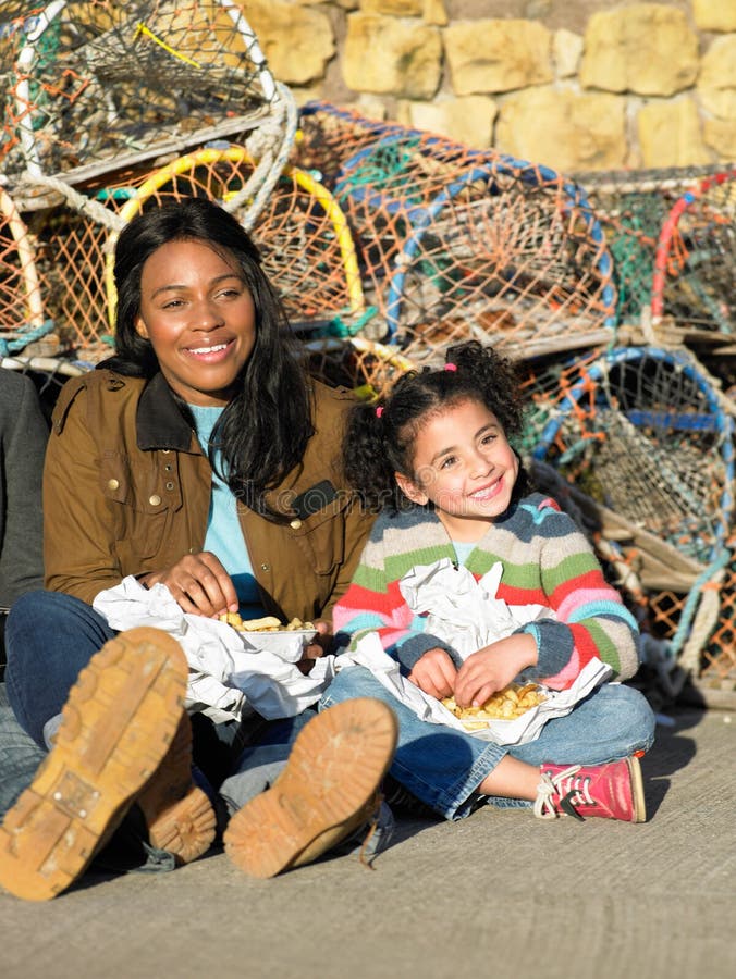 Mother with Girl Sitting on Sand Stock Photo - Image of sitting, fries ...
