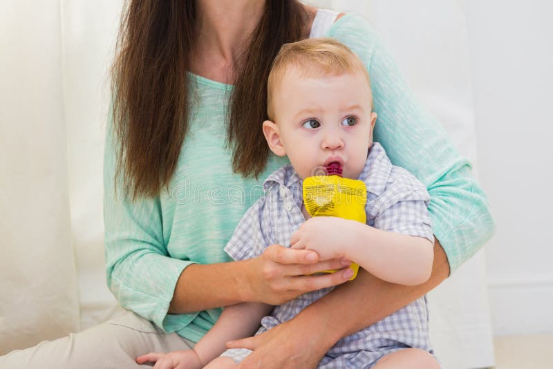 Mother giving baby a drink stock photo. Image of child - 54775522
