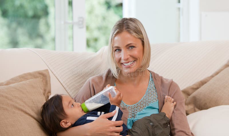 Mother Giving a Bottle of Milk To Her Son Stock Image - Image of ...