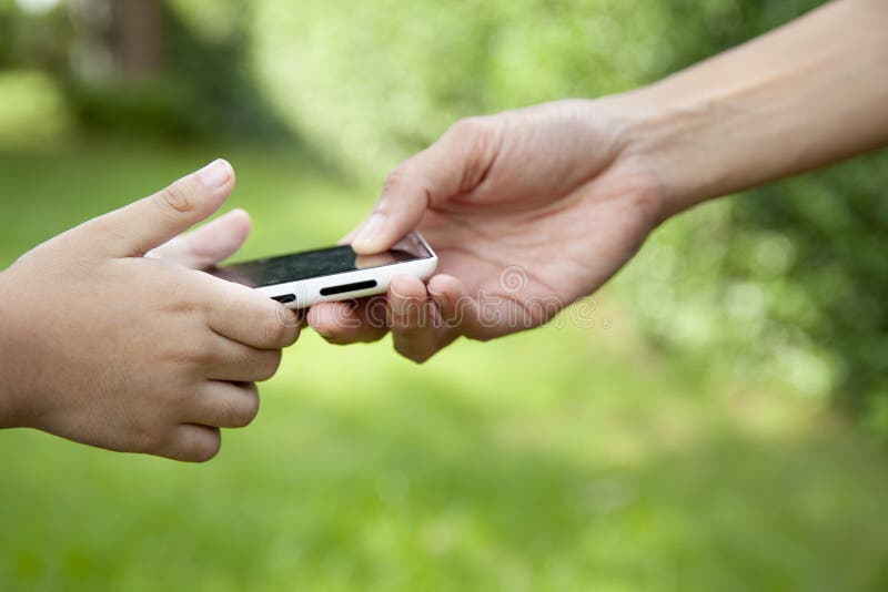 Mother Giving Her Child a Mobile Phone Stock Photo - Image of family ...