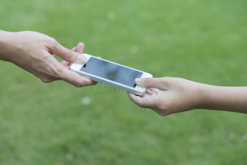 Mother Giving Her Child a Mobile Phone Stock Photo - Image of family ...