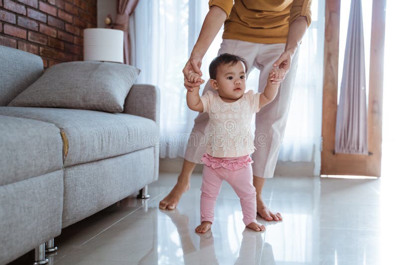 Mother Help Her Baby To Walk Her First Step Stock Image - Image of ...