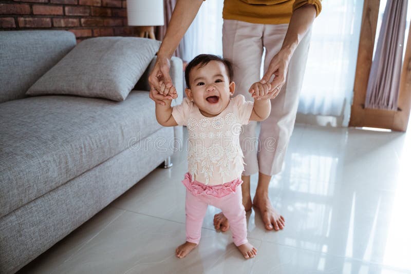 Mother Help Her Baby To Walk Her First Step Stock Photo - Image of girl ...